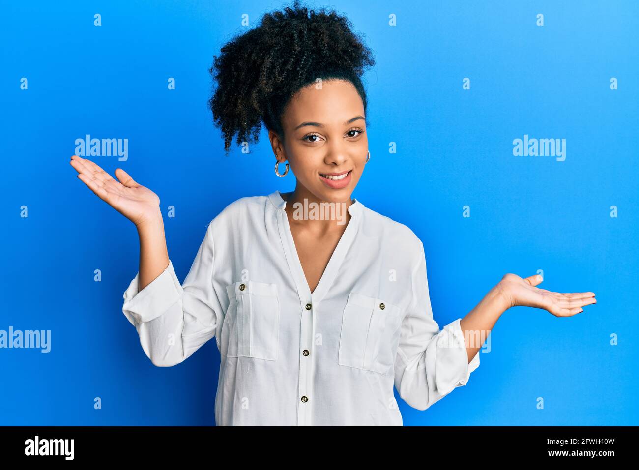 Young african american girl wearing casual clothes clueless and ...