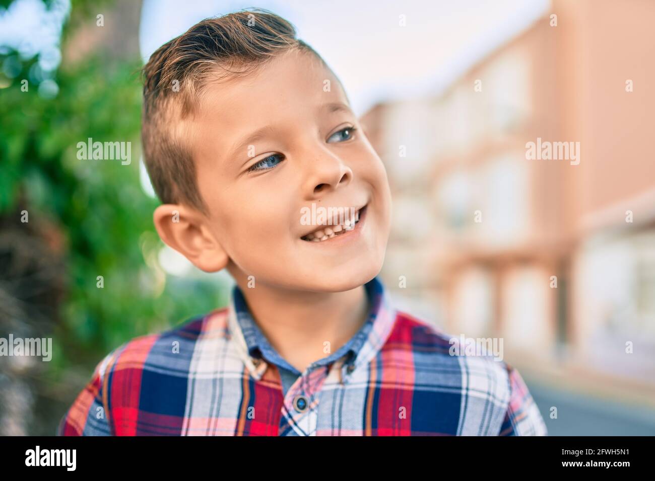 Adorable caucasian boy smiling happy standing at the city Stock Photo - Alamy