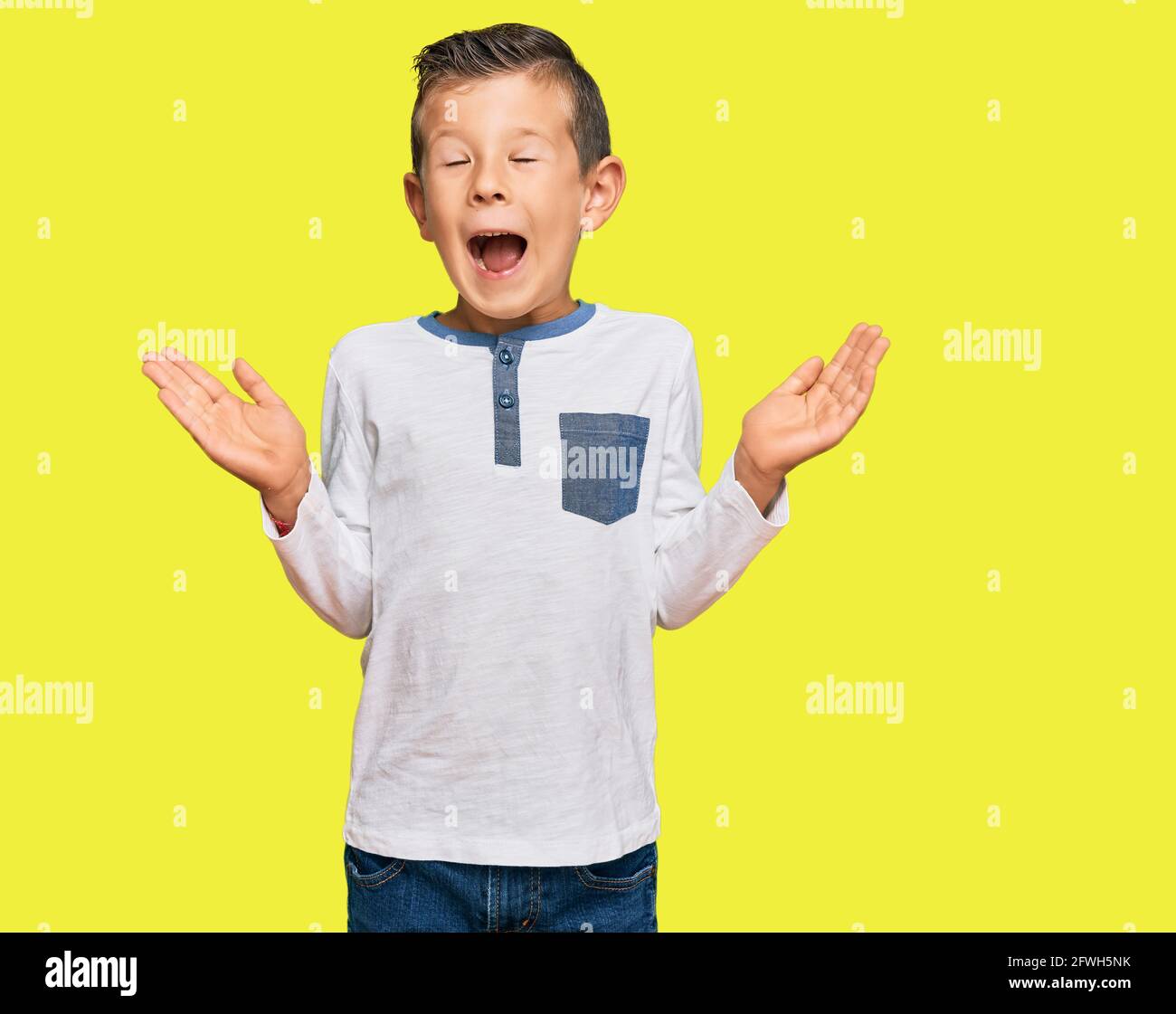 Adorable caucasian kid wearing casual clothes celebrating mad and crazy ...