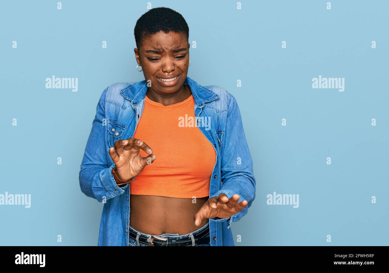 Young african american woman wearing casual clothes disgusted ...