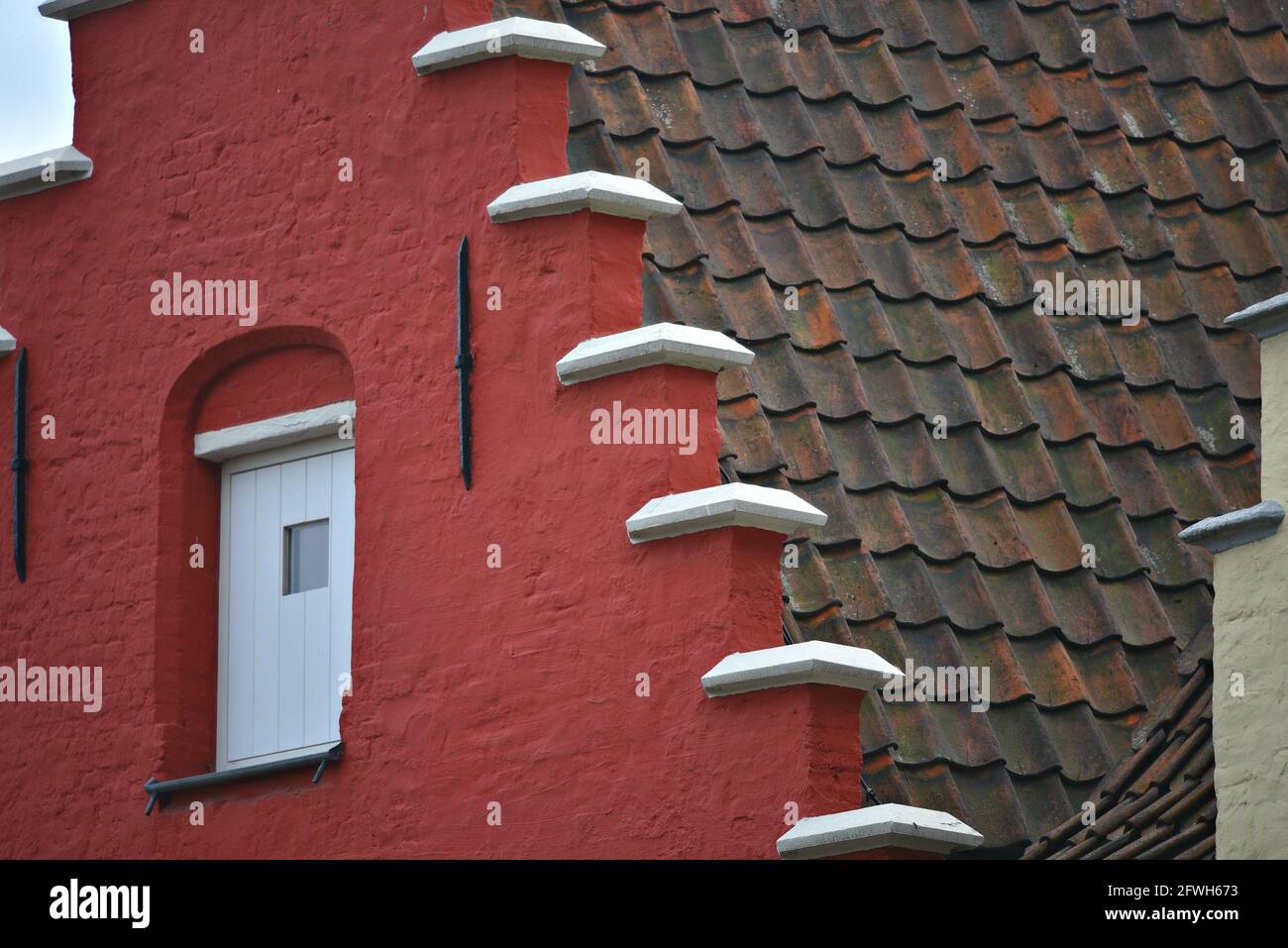 Old Gothic Revival style house with a shingles rooftop, a Venetian red ...