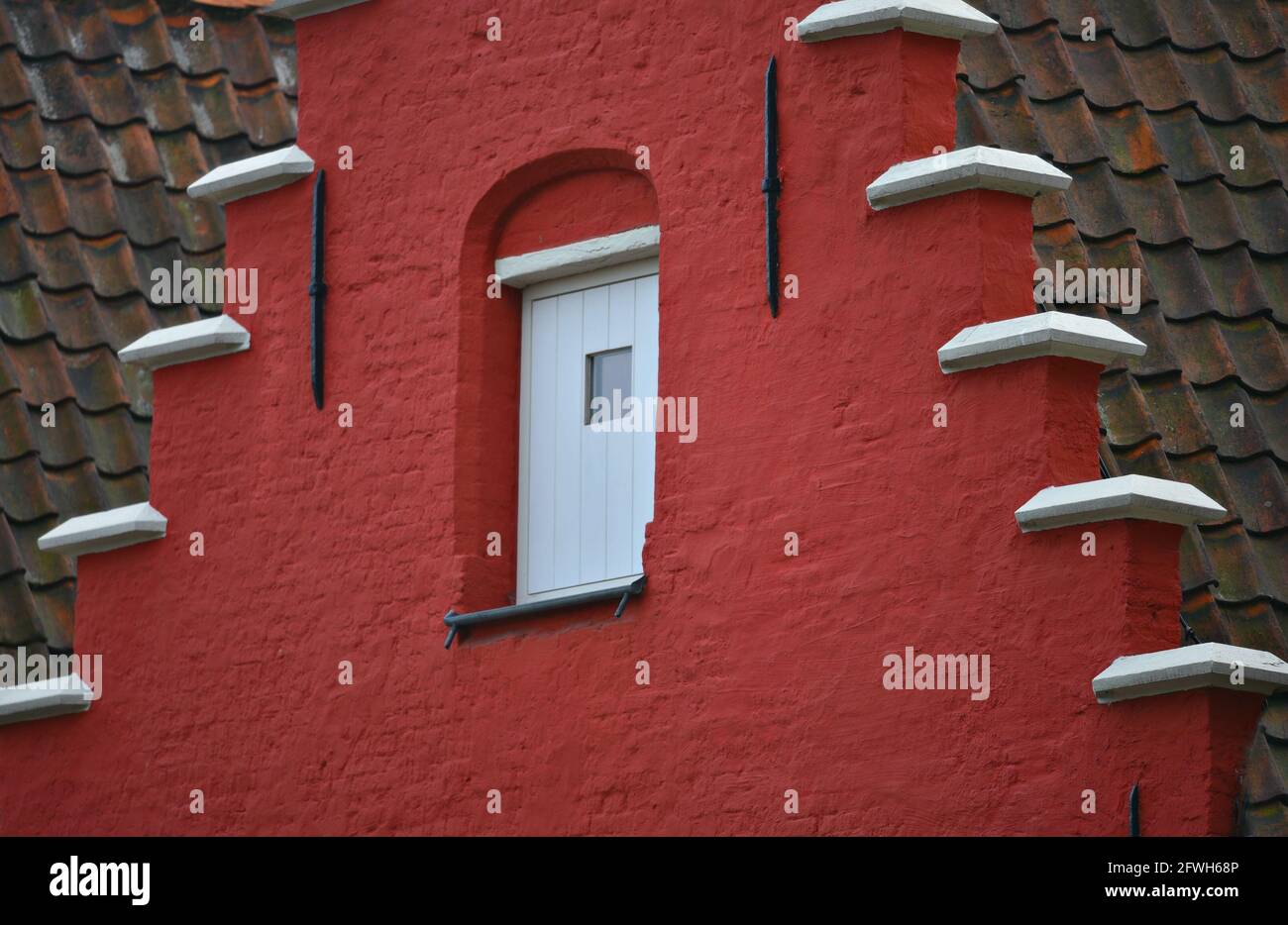Old Gothic Revival style house with a shingles rooftop, a Venetian red ...