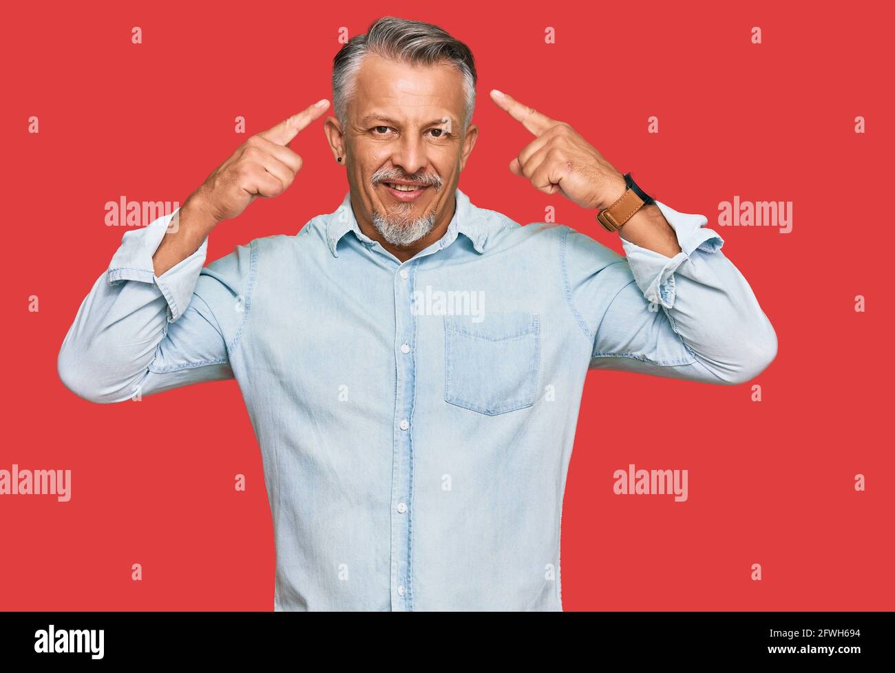 Middle age grey-haired man wearing casual clothes smiling pointing to ...