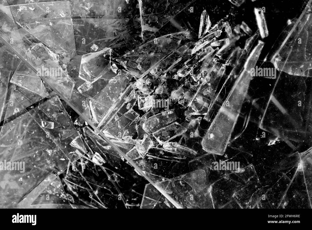 Broken glass shards dark background Black and White Stock Photos ...