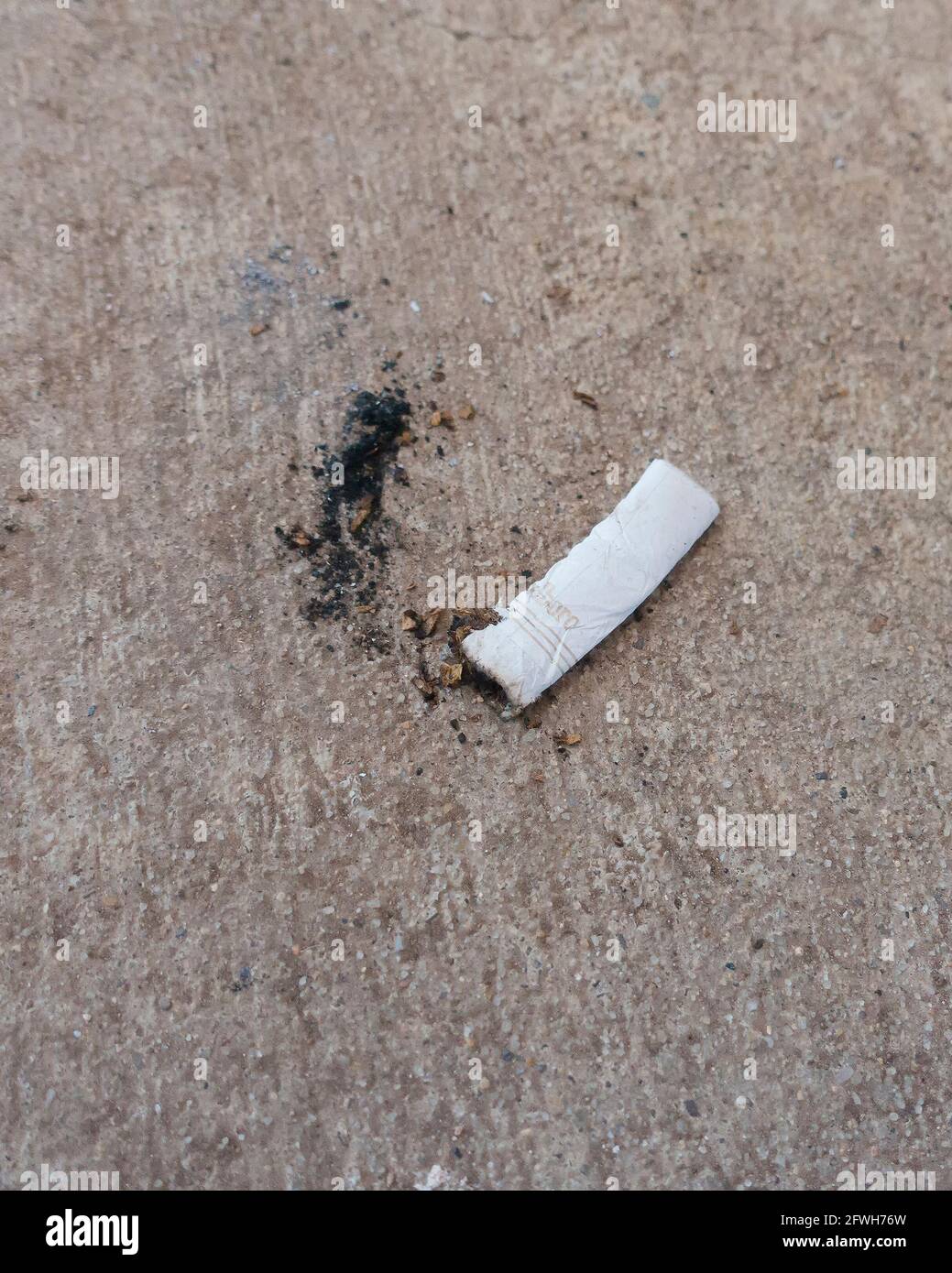 Stepped on cigarette butt on ground - USA Stock Photo - Alamy