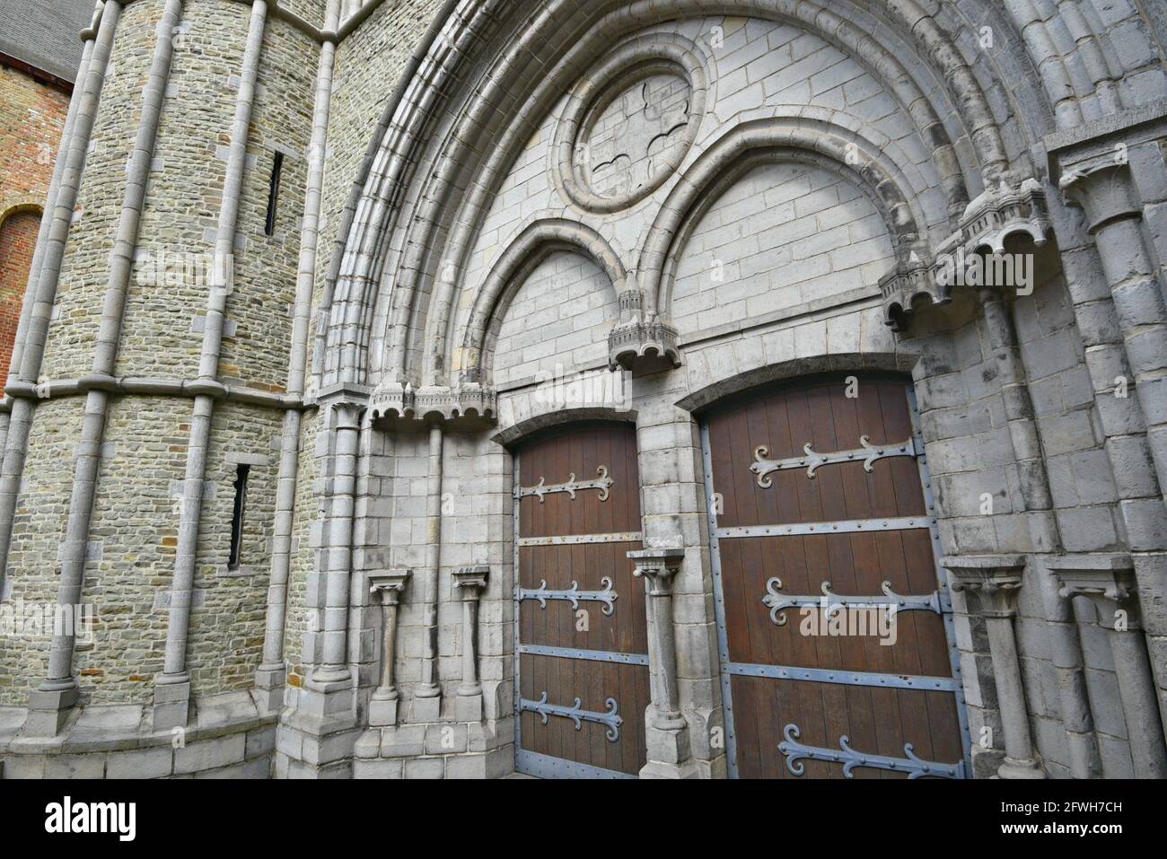 Medieval stone arched entrance gate with wooden doors and wrought iron ...