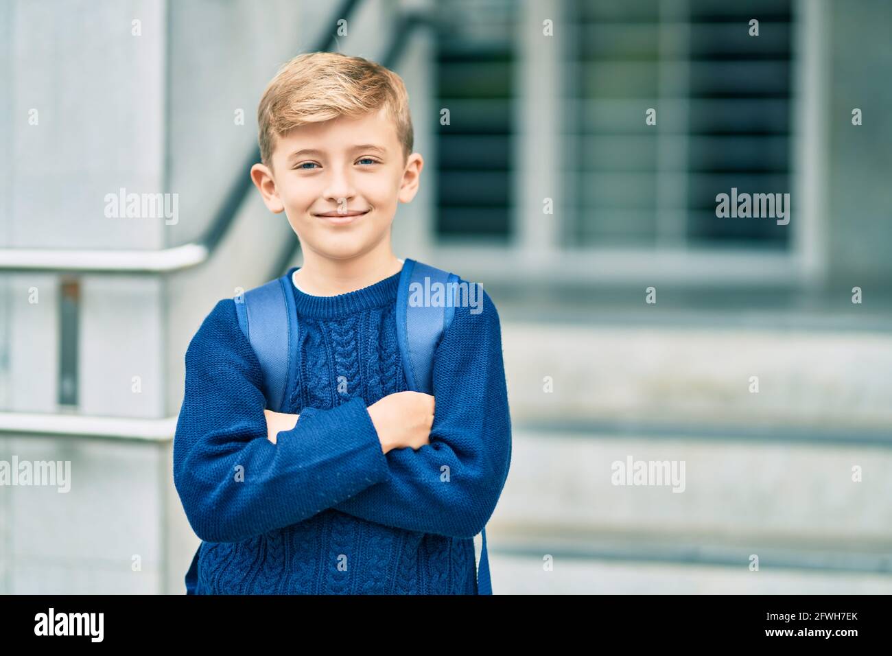 Adorable blond student kid smiling happy standing at the school Stock ...