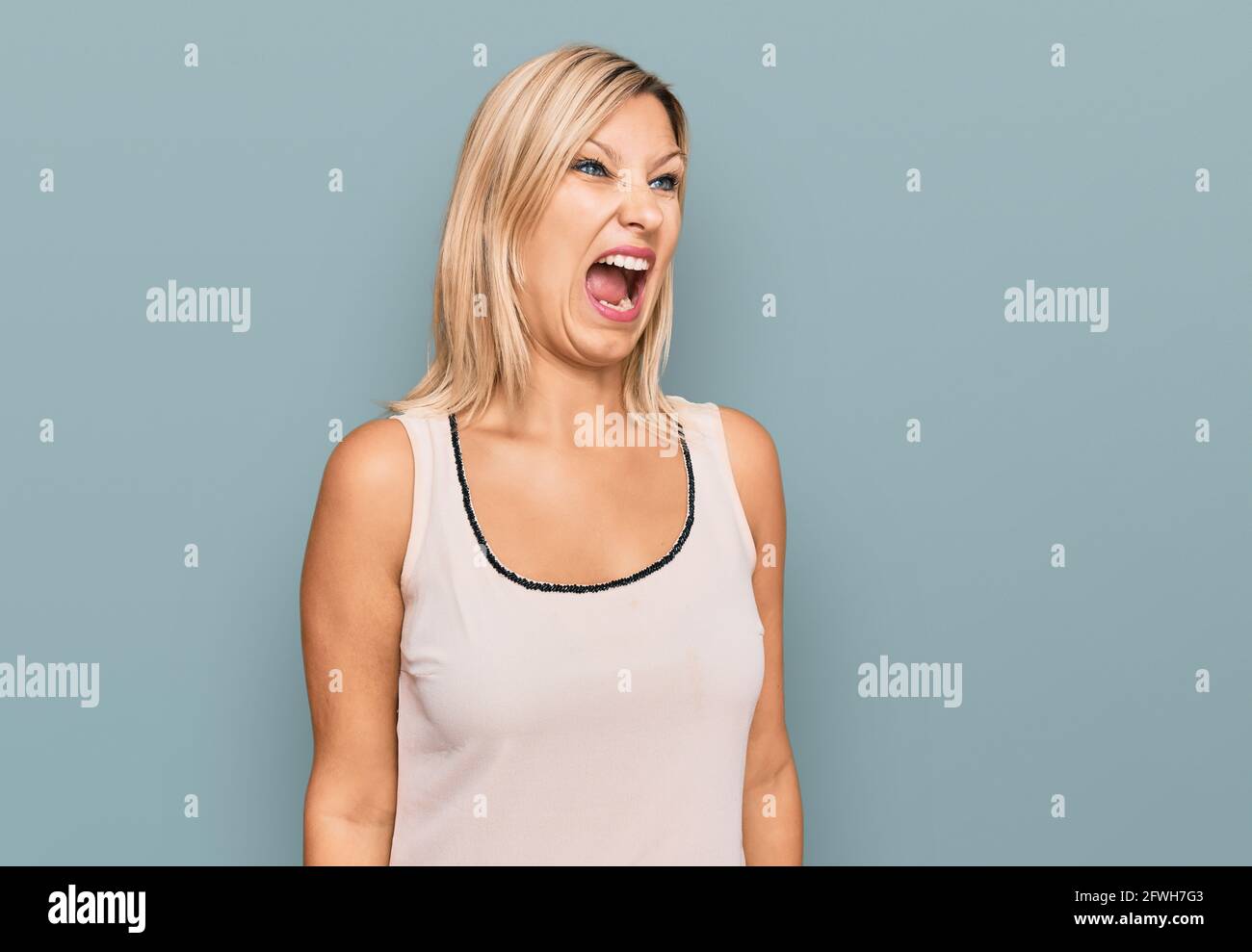 Middle age caucasian woman wearing casual clothes angry and mad ...
