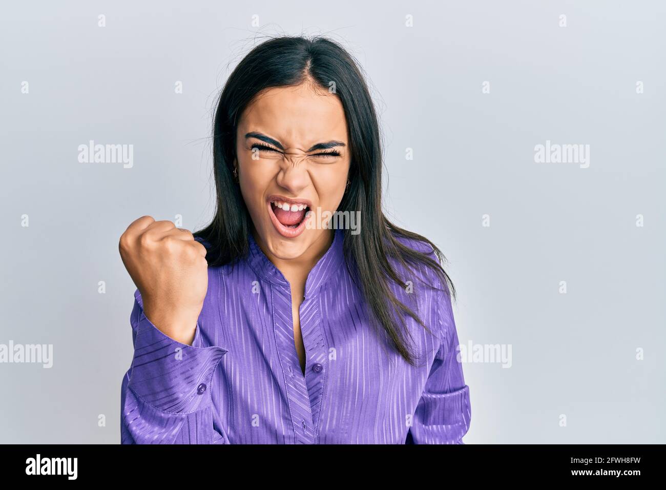 Young Brunette Woman Wearing Casual Clothes Angry And Mad Raising Fist