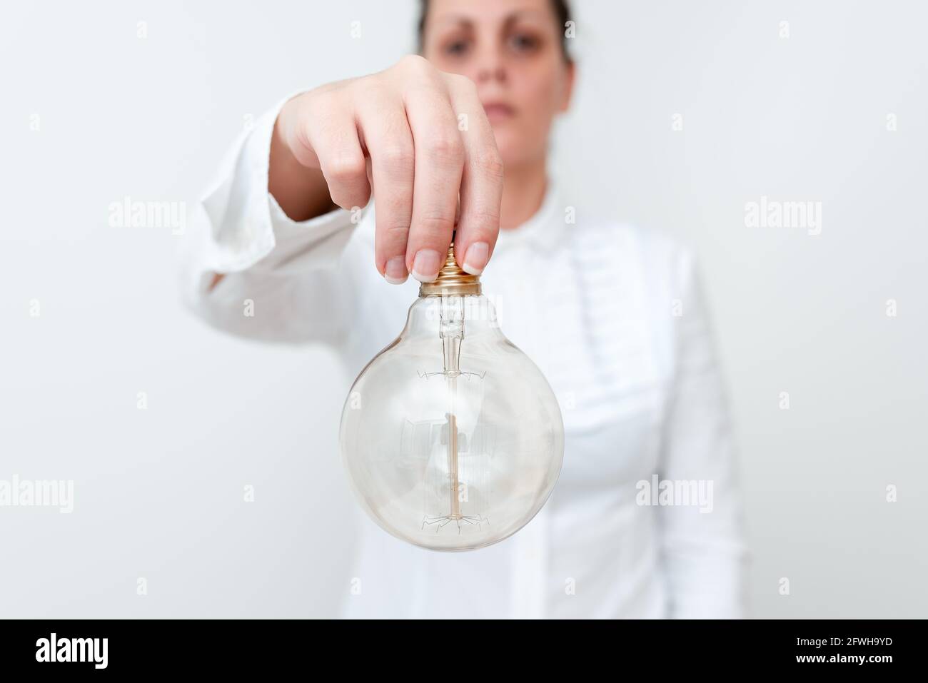 Lady Holding Lamp Upside Down In Shirt Presenting New Ideas For Project ...