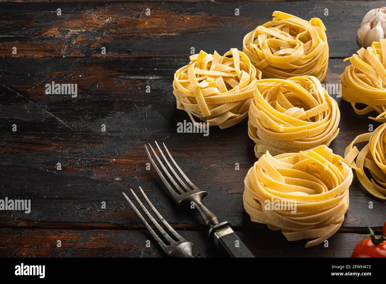 Rolled tagliatelle shape of italian pasta with ingredients set, on old ...
