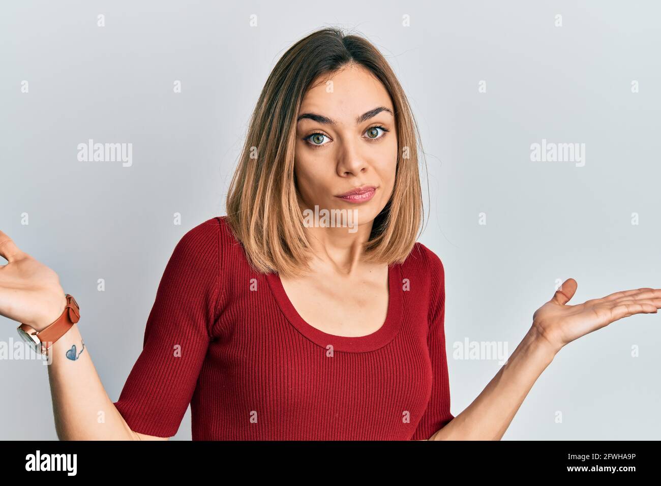 Young caucasian blonde woman wearing casual jumper clueless and ...