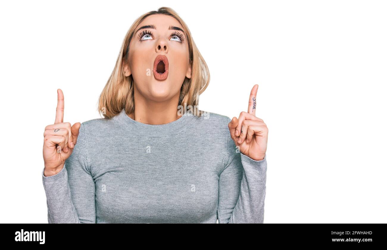 Young caucasian woman wearing casual clothes amazed and surprised ...