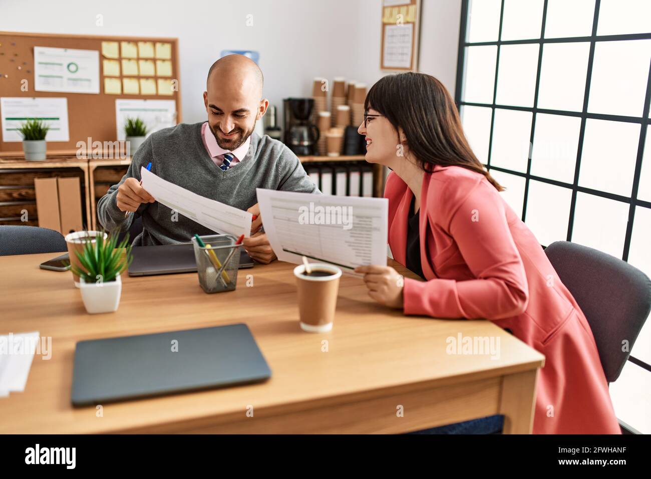 Two hispanic business workers smiling happy working at the office Stock ...