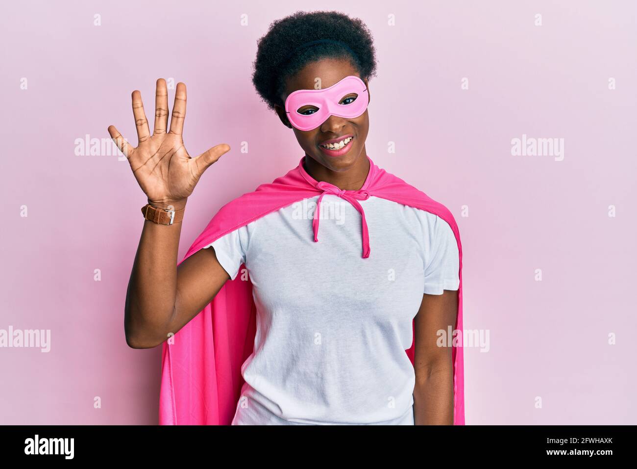 Young african american girl wearing superhero mask and cape costume ...