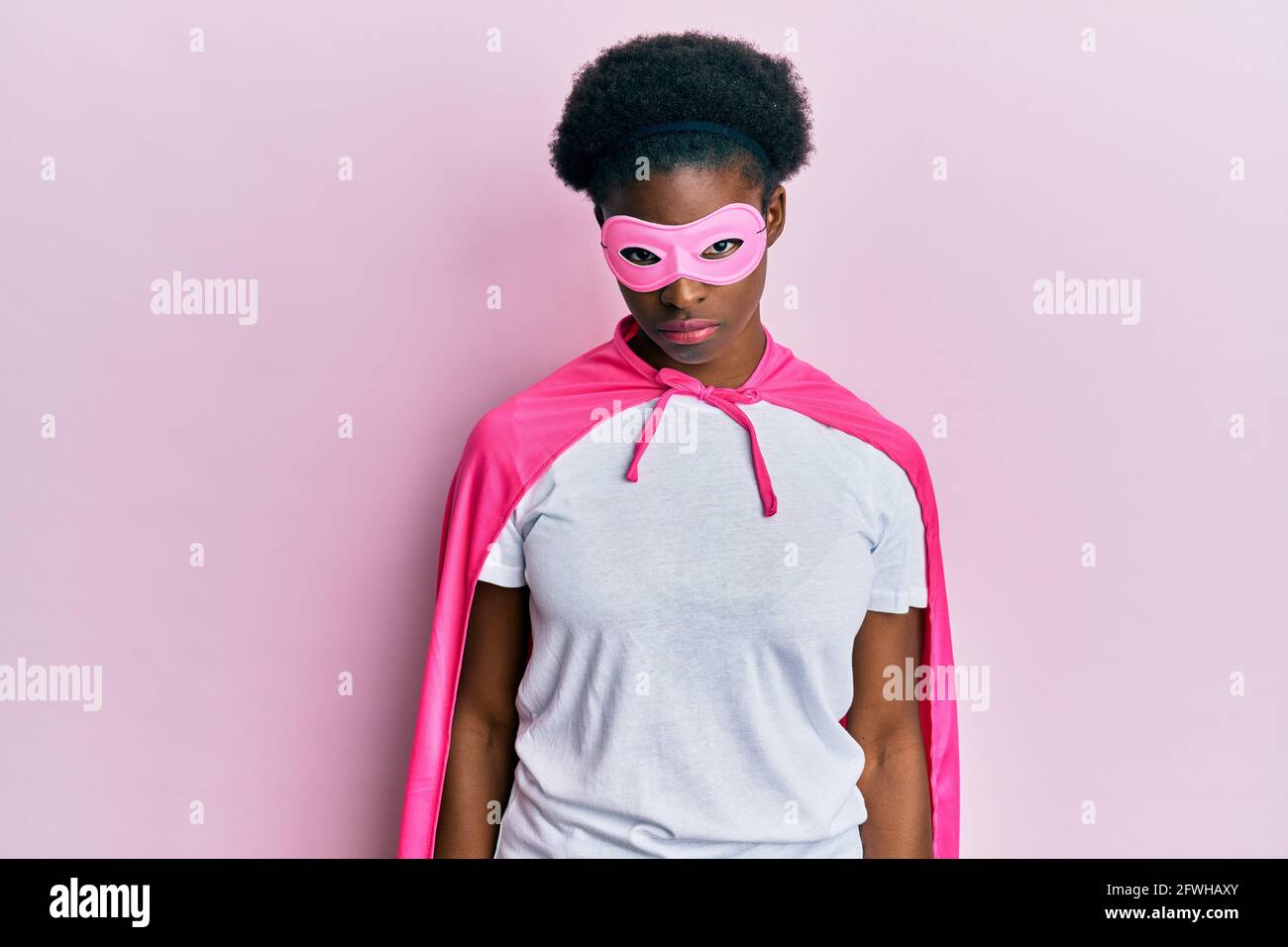 Young african american girl wearing superhero mask and cape costume ...