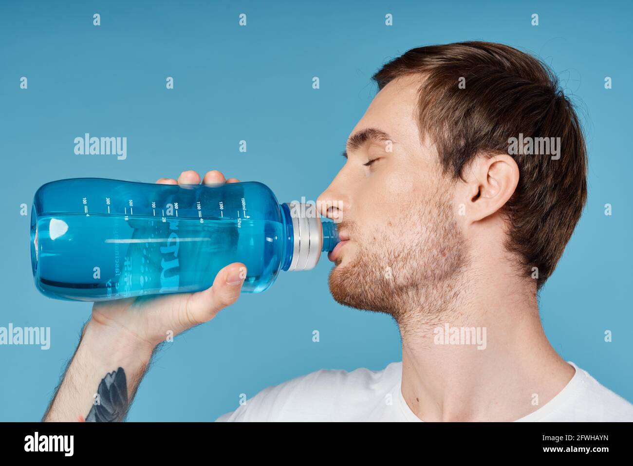 man drinking water from blue bottle fitness workout thirst Stock Photo ...