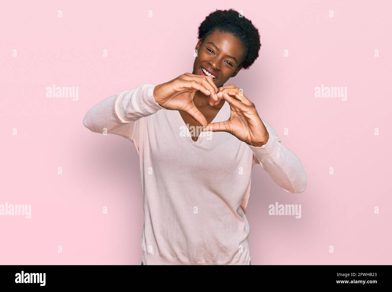 Young african american girl wearing casual clothes smiling in love ...