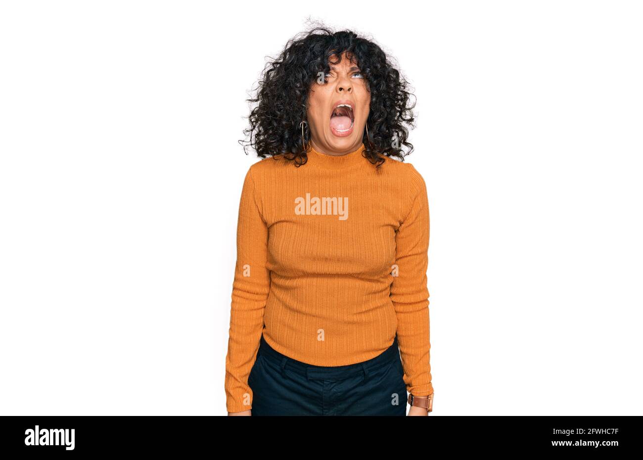 Young hispanic woman wearing casual clothes angry and mad screaming ...