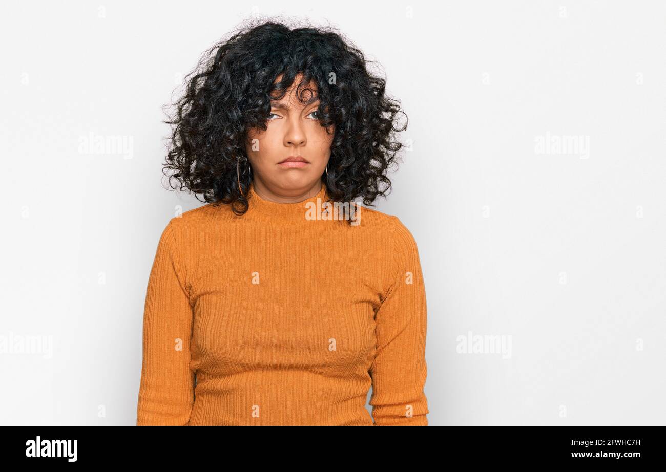 Young hispanic woman wearing casual clothes skeptic and nervous ...