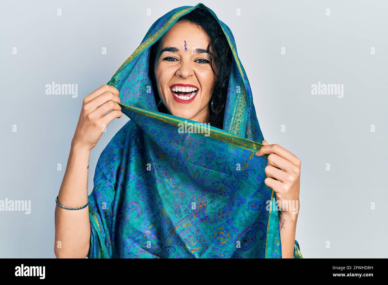 Young woman wearing bindi wearing traditional indian saree looking at ...