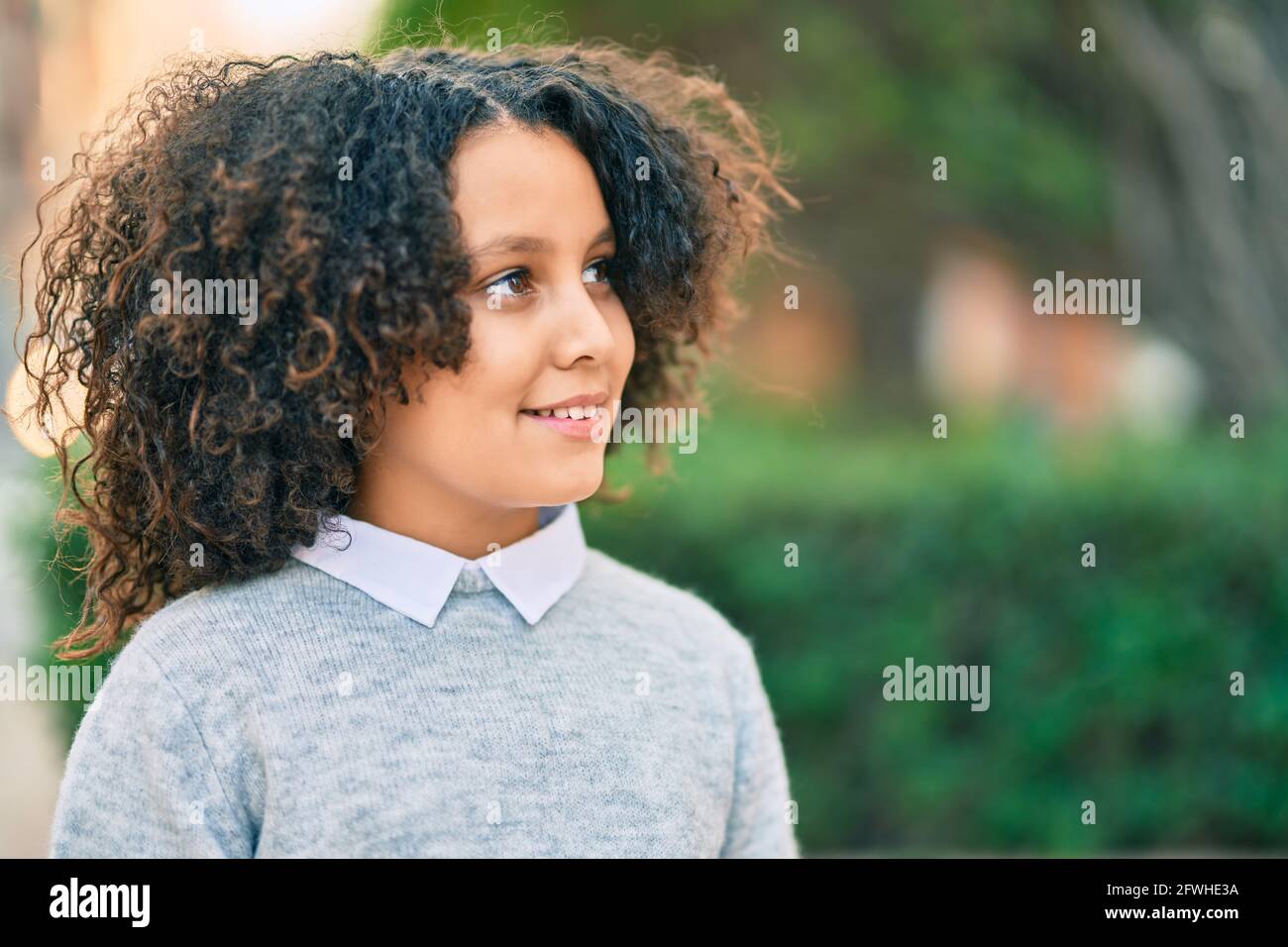 Adorable hispanic child girl smiling happy standing at the park Stock ...