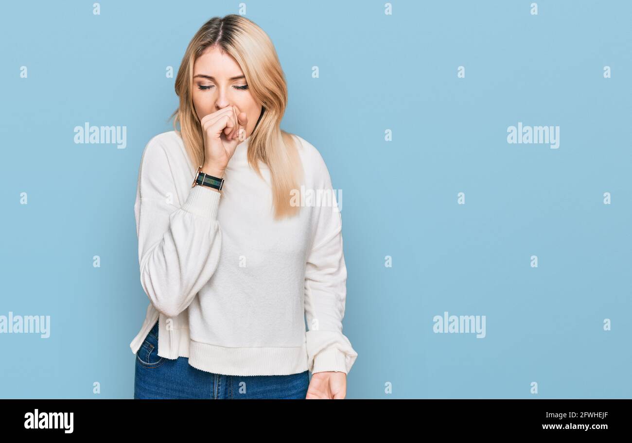 Young caucasian woman wearing casual winter sweater feeling unwell and ...
