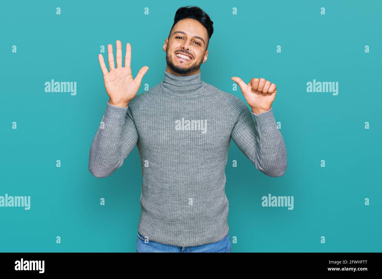 Young arab man wearing casual clothes showing and pointing up with ...