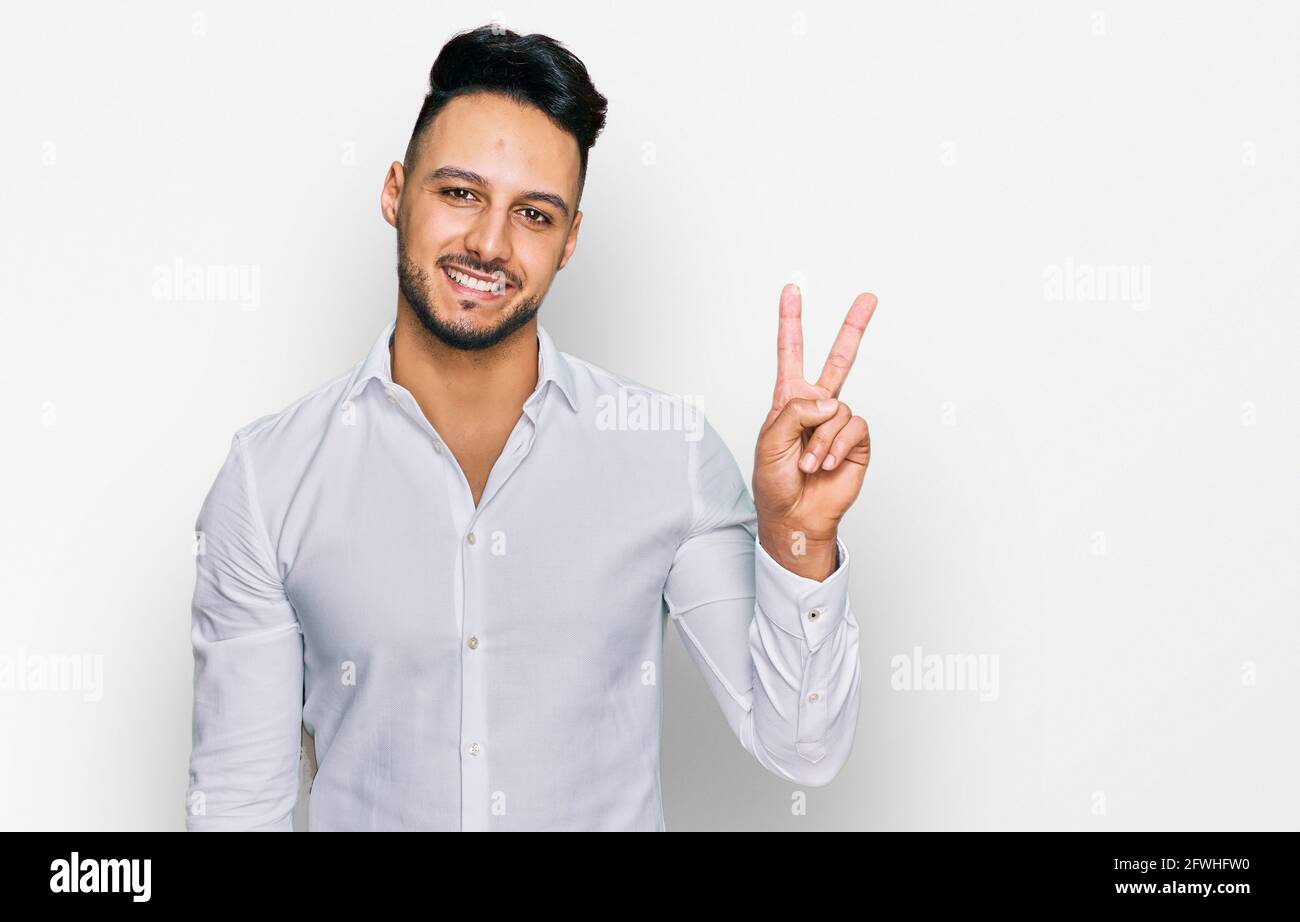 Young arab man wearing casual clothes showing and pointing up with ...