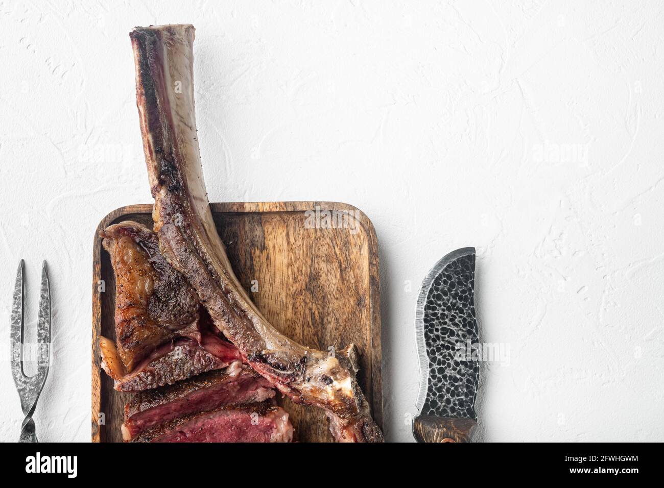 Medium rare Tomahawk meat marbled dry aged beef grilled set, on wooden ...