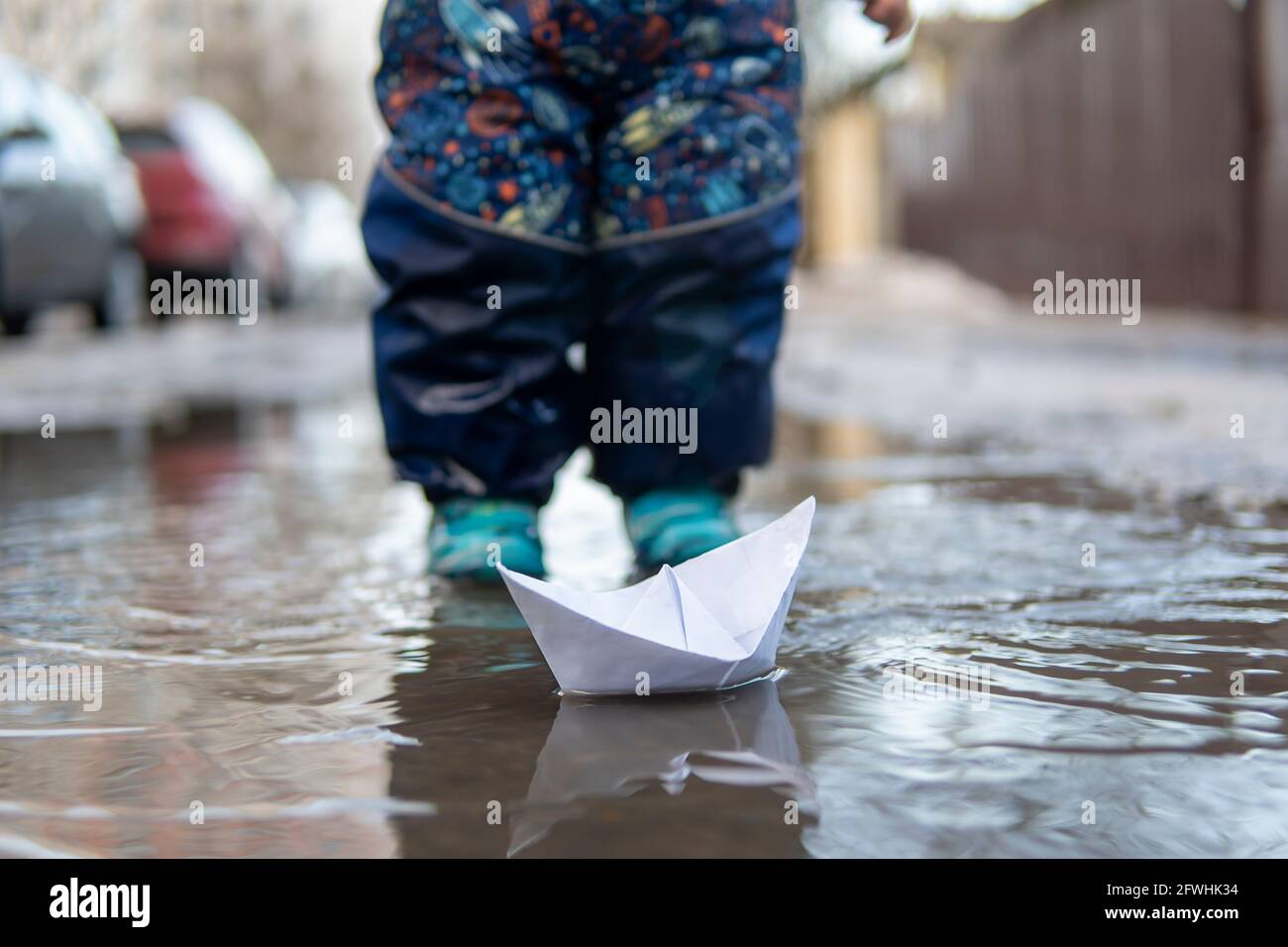 Paper boat in puddle in hi-res stock photography and images - Alamy