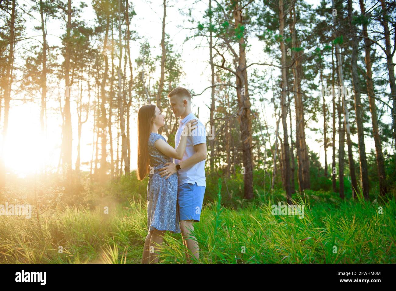 Happy couple in love in springtime at sunset. Woman and man holding ...