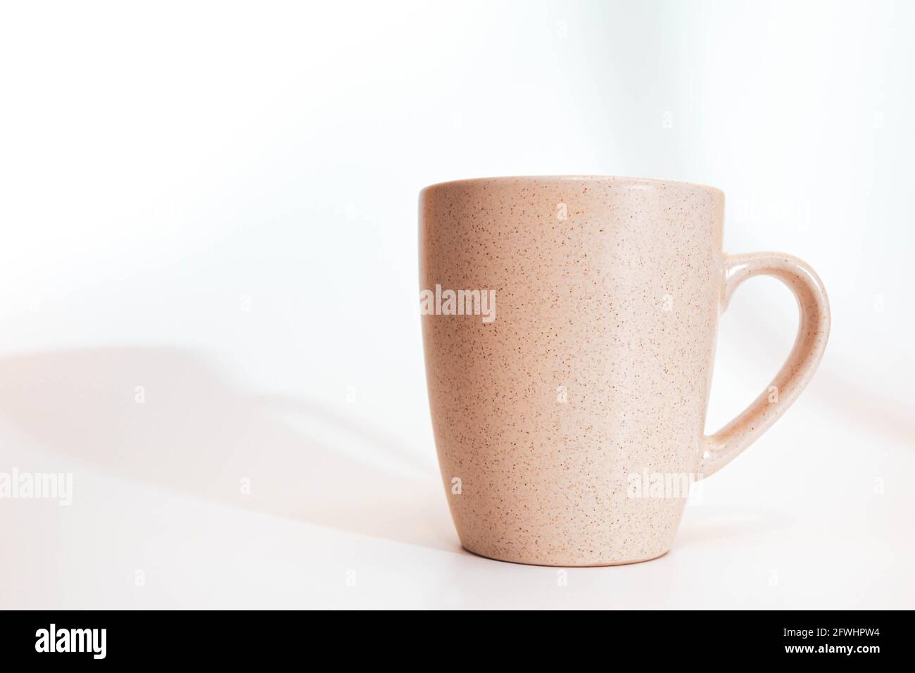 Gently cream-colored cup in brown speck on a white background Stock ...