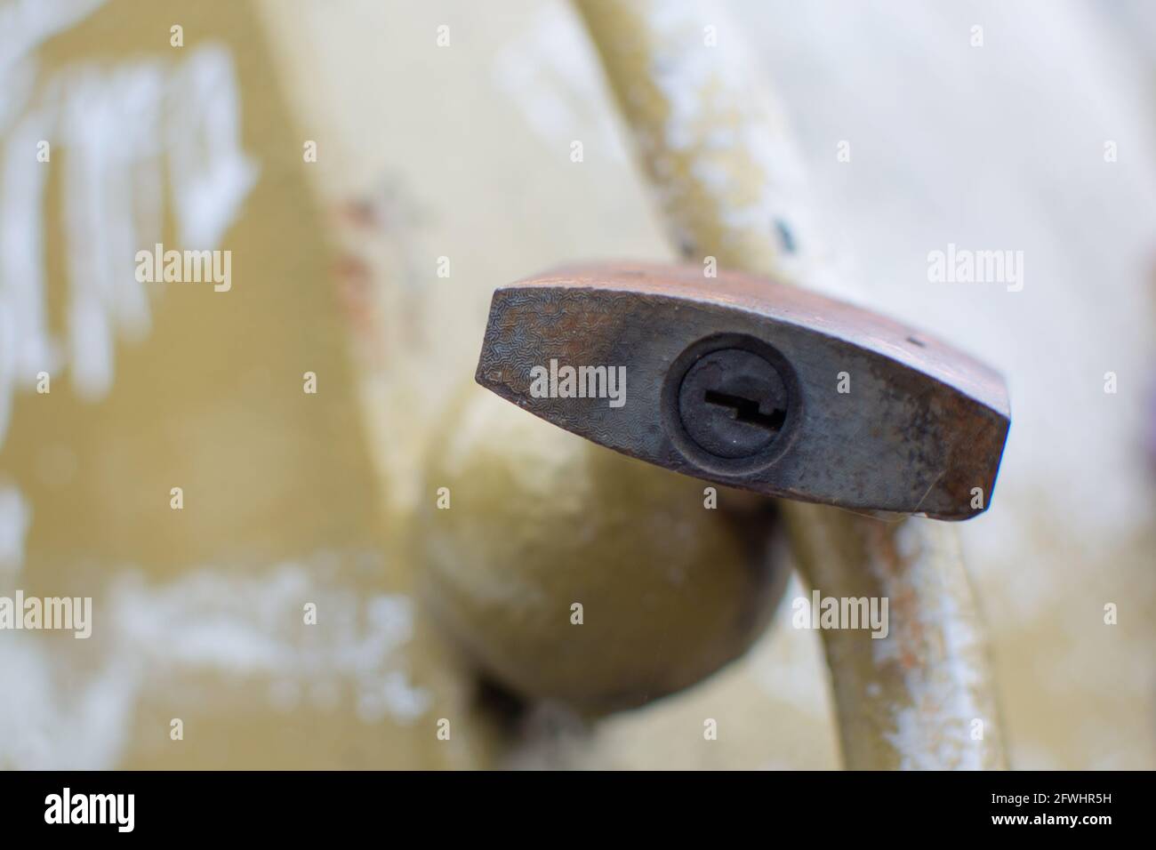 Keyhole of an old padlock hanging from a railing Stock Photo - Alamy