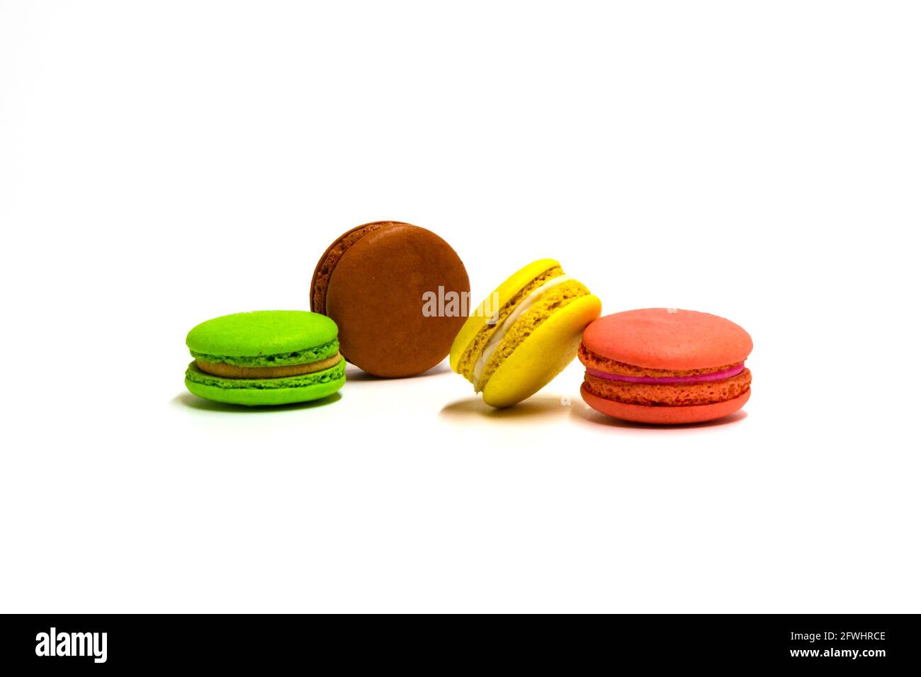 multicolored four macaroons on a white background Stock Photo - Alamy