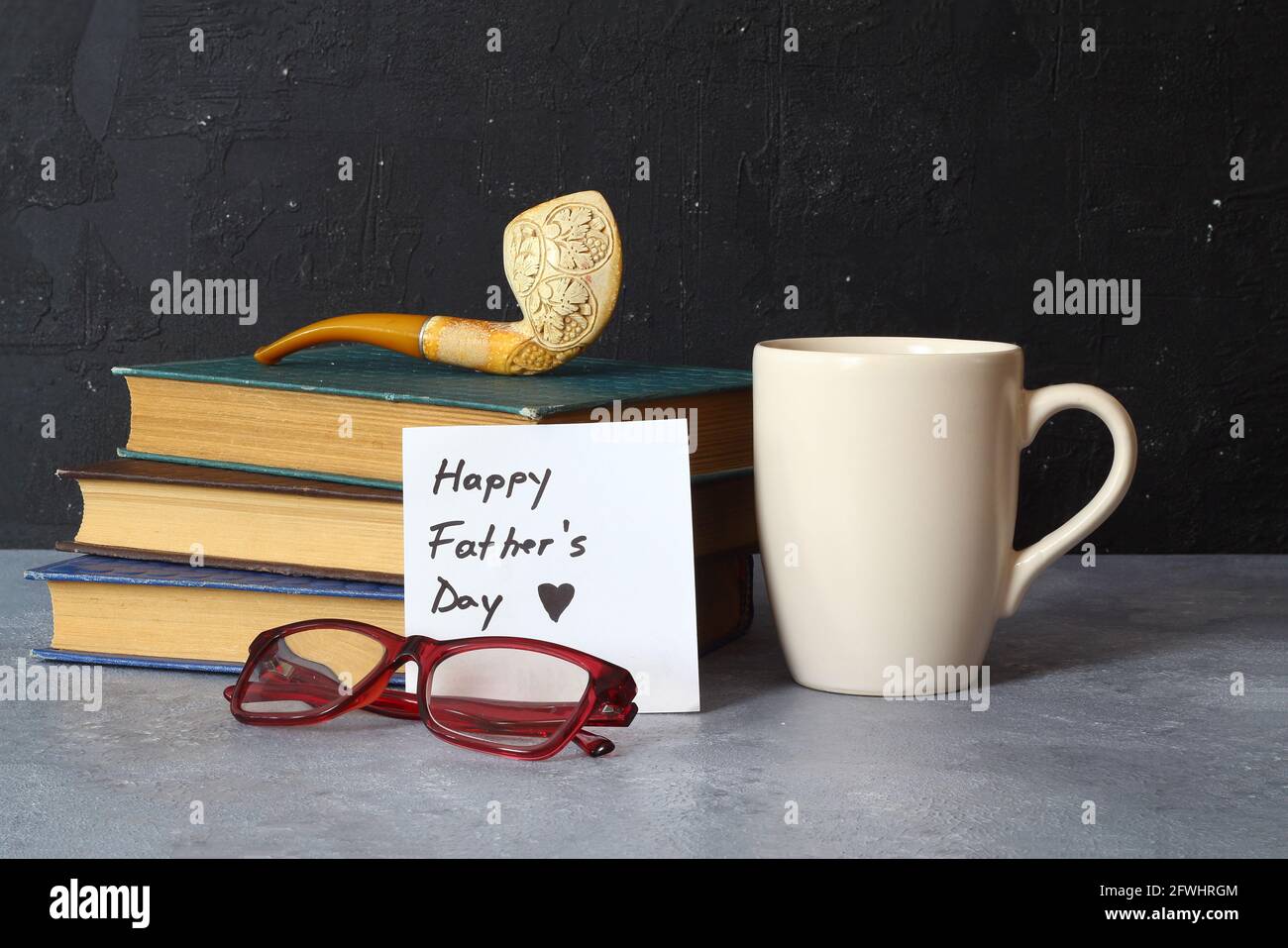 Happy Fathers day concept with coffee cup, pipe, glasses and books over ...