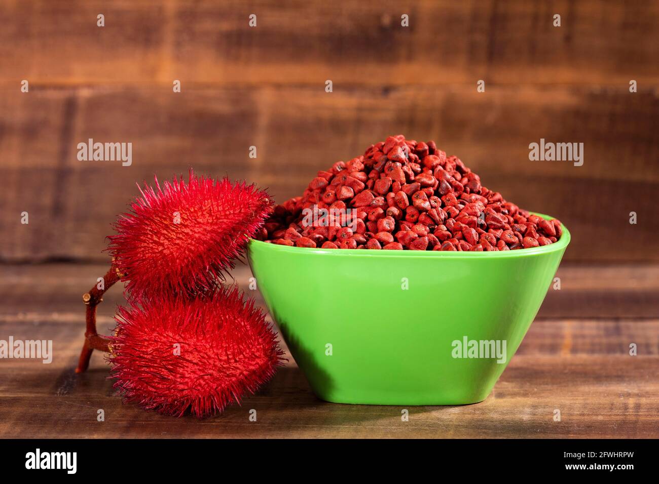 Bixa orellana - Organic achiote in the green bowl Stock Photo - Alamy