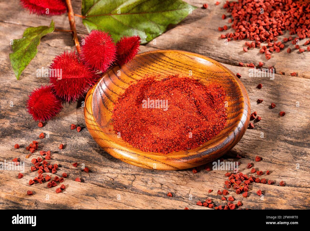 Bixa orellana - Red achiote seeds powder Stock Photo - Alamy
