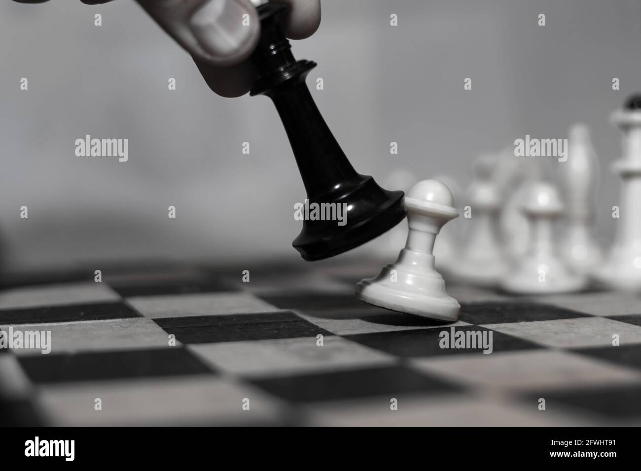 Game of chess. The king knocks over a pawn Stock Photo - Alamy