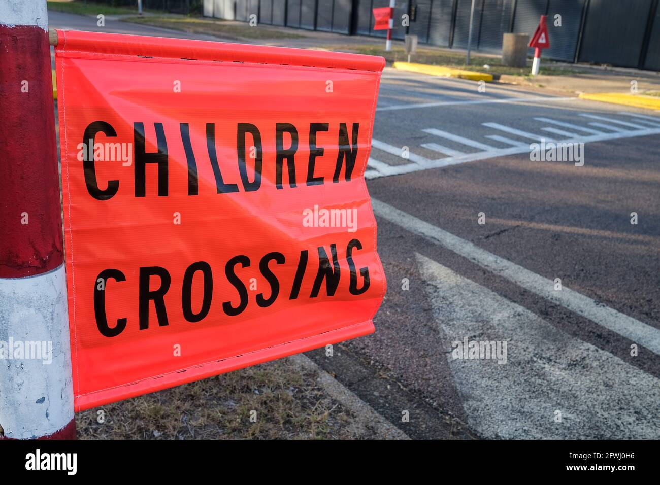 Children crossing road sign flag Stock Photo - Alamy