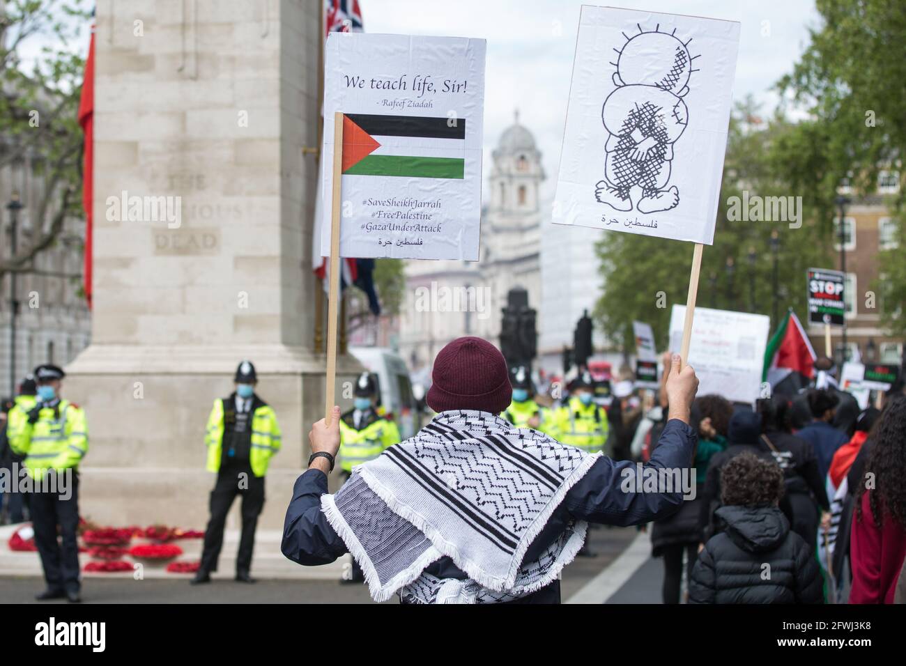 London, UK. 22 May, 2021. A man passes the Cenotaph holding a placard ...