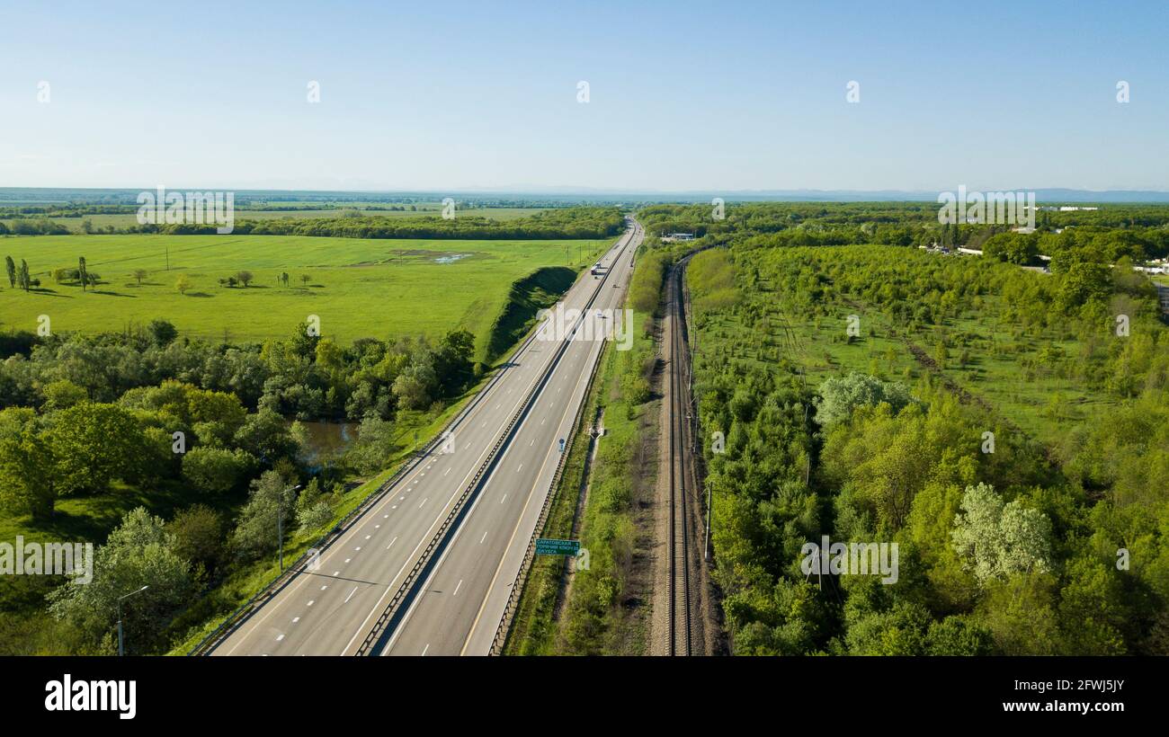 Overhead aerial: car driving through pine forest. Russian landscape ...