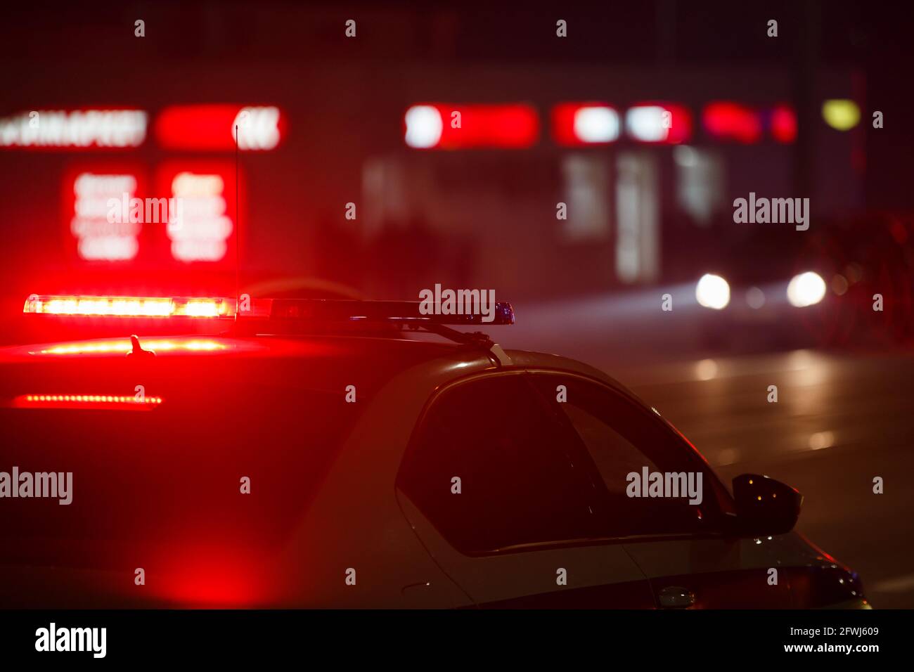 red police car light at night in city with selective focus and blurry ...