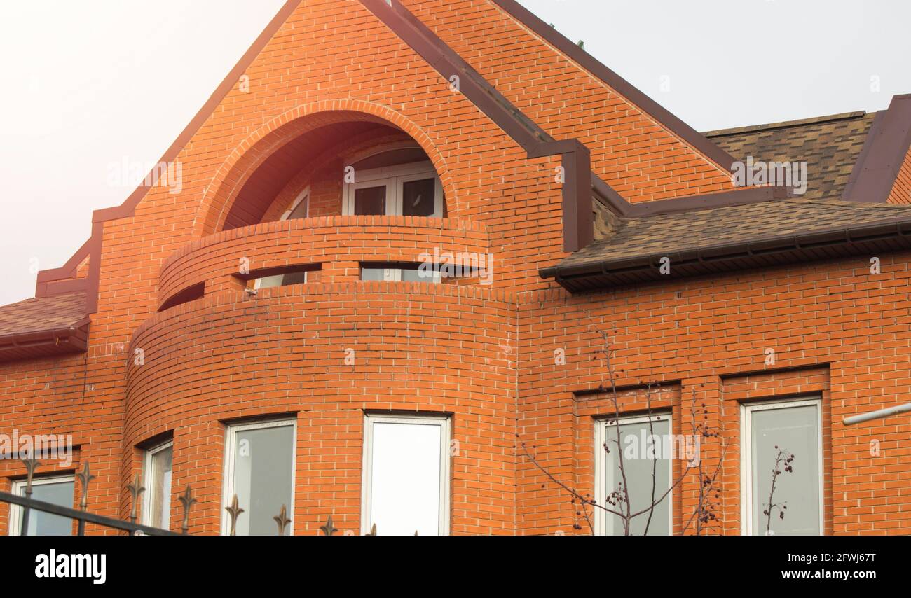 Close-up of a part of the facade of a red brick cottage house with ...