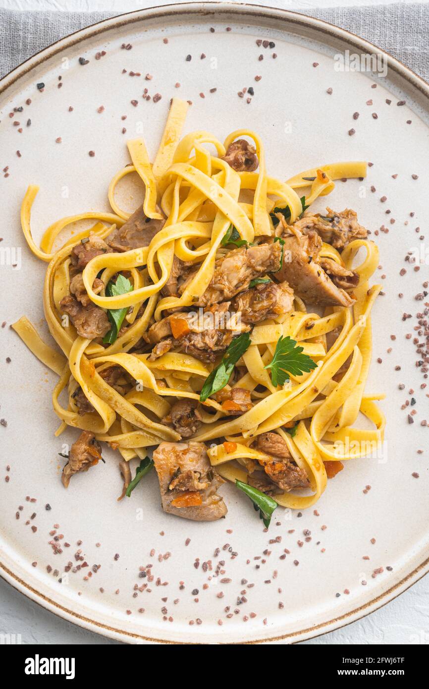 Tasty spicy rabbit stew with pasta tagliatelle or pappardelle set, on ...