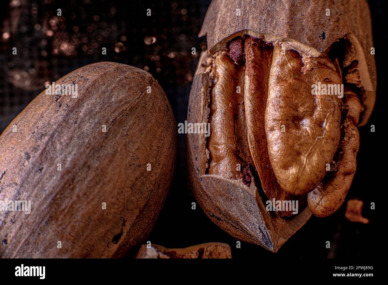 Dried pecan nuts and pecan nut's shells on a wooden table, close up ...