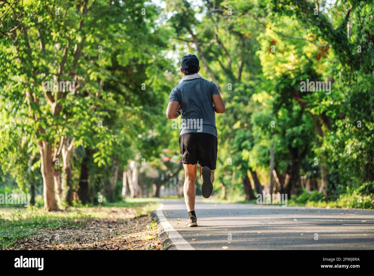 Asian male young running listening hi-res stock photography and images ...
