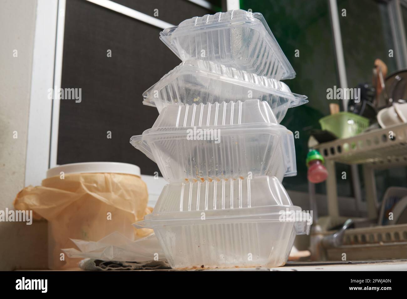 Stack of plastic boxes after lunch in the kitchen Stock Photo - Alamy