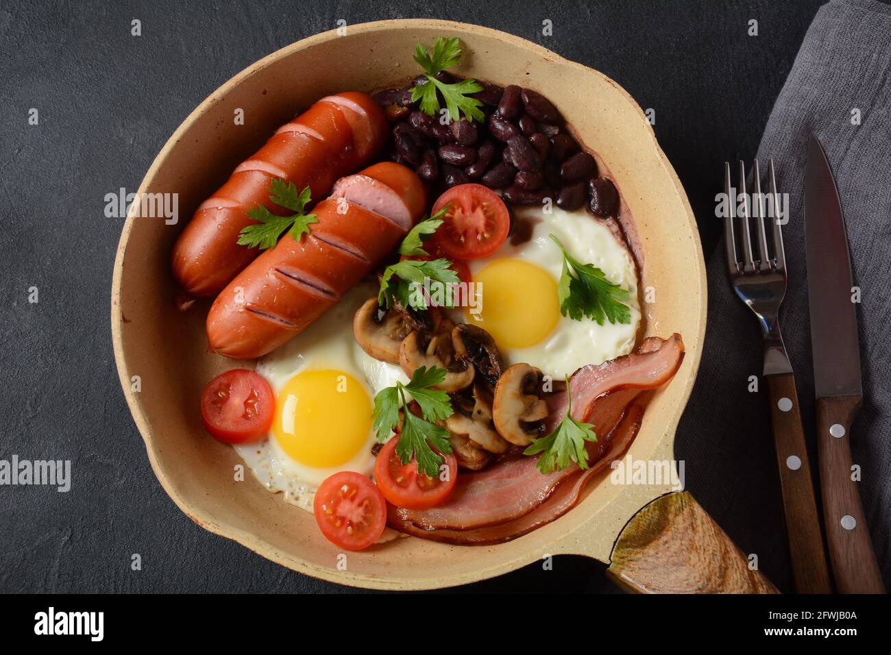 Traditional full English breakfast with bacon, fried eggs, sausages ...