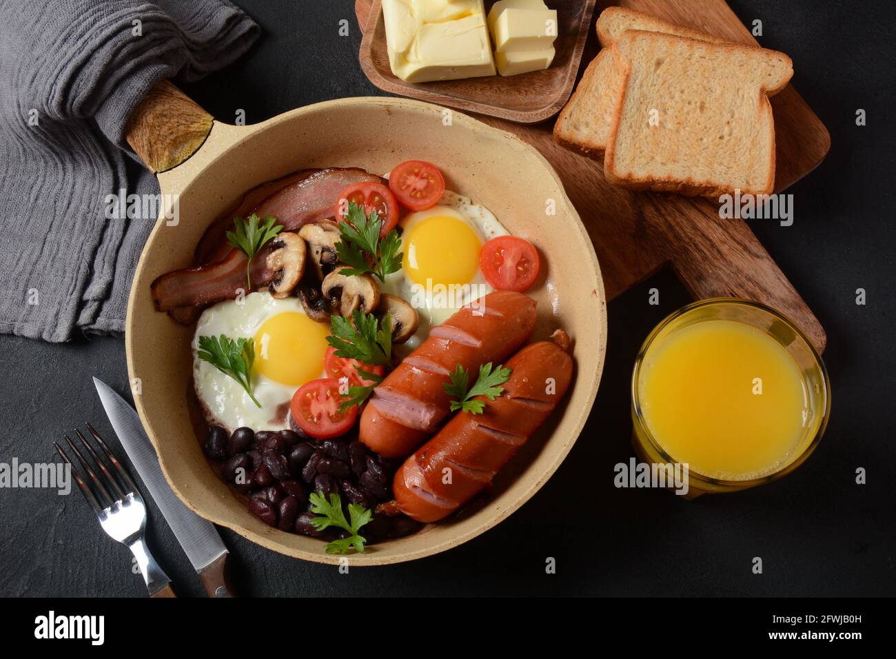 Traditional full English breakfast with bacon, fried eggs, sausages ...